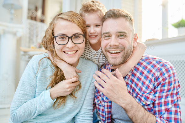 Portrait of Happy Family with One Child Stock Photo by seventyfourimages