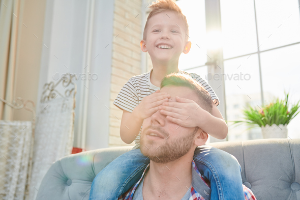 Cute Little Boy Sitting on Dads Shoulders Stock Photo by seventyfourimages