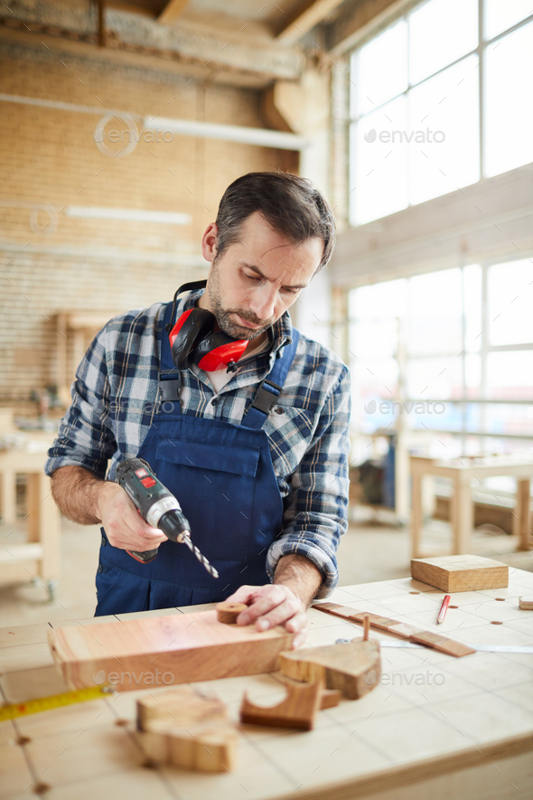 Skilled carpenter Making Wooden Toys Stock Photo by seventyfourimages