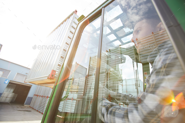 Loader man in machine Stock Photo by Pressmaster | PhotoDune