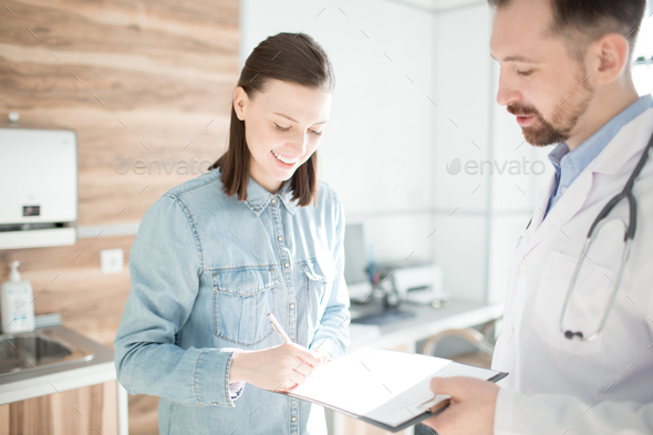 Signing medical paper Stock Photo by Pressmaster | PhotoDune