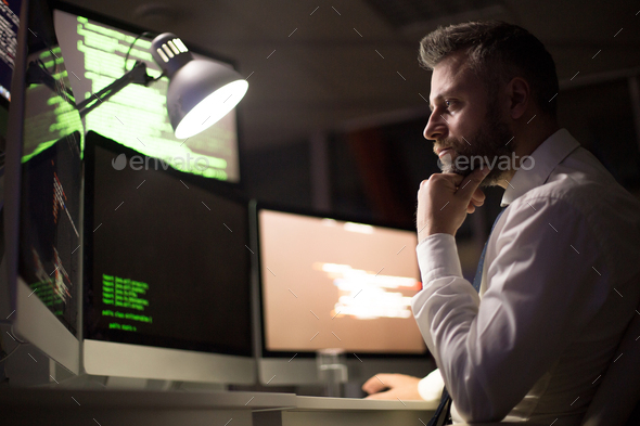 Bearded Coder Concentrated on Work Stock Photo by seventyfourimages