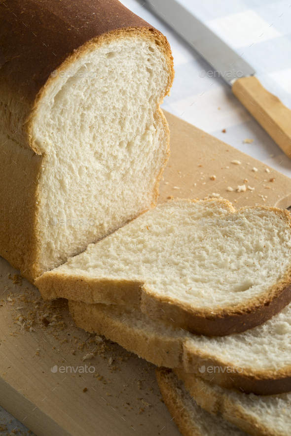 Fresh baked white bread cut into slices Stock Photo by picturepartners