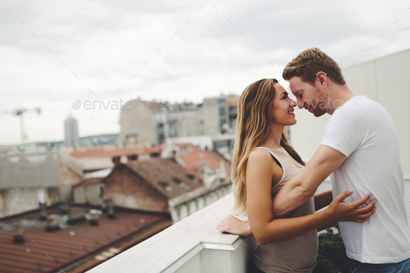 Romantic couple on rooftop Stock Photo by nd3000 | PhotoDune