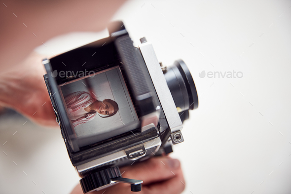 Photographer Looking Into Viewfinder Of Vintage Medium Format Camera On ...