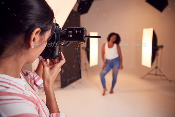 Model Posing For Female Photographer In Studio Portrait Session Stock ...