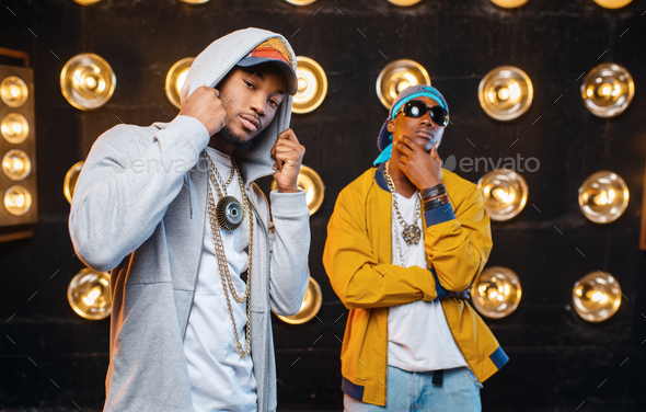 Two black rappers in caps on stage with spotlights Stock Photo by ...