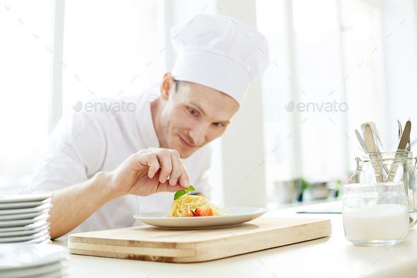 Finishing cooking Stock Photo by Pressmaster | PhotoDune