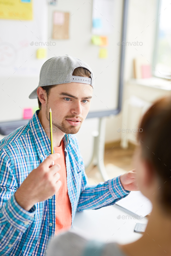 Explaining task solution Stock Photo by Pressmaster | PhotoDune