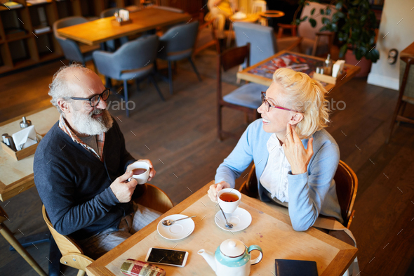 Conversation by cup of tea Stock Photo by Pressmaster | PhotoDune