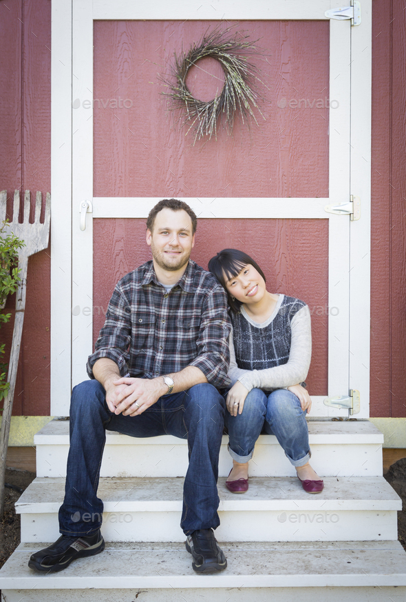 Happy Mixed Race Couple Relaxing on the Steps of Their Barn. Stock ...