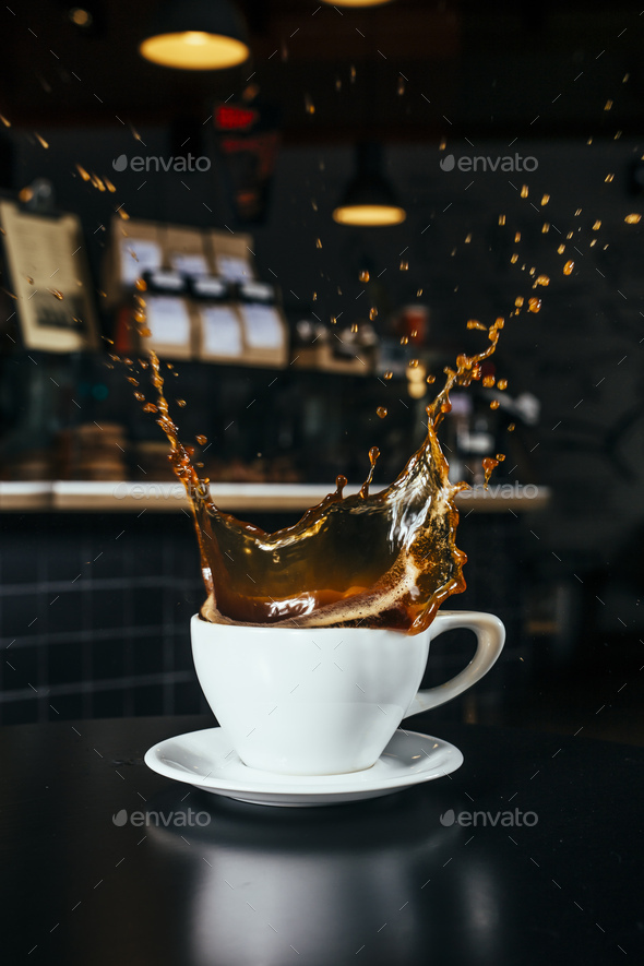 Coffee exploding out of a white cup in a Coffee Shop Stock Photo by ...