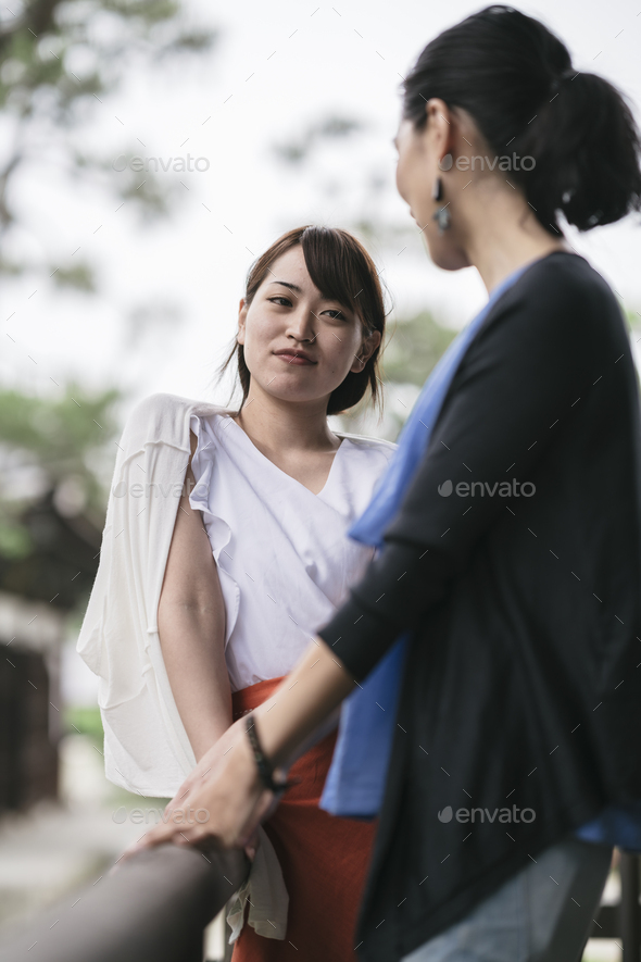 two young japanese woman talking Stock Photo by jpozzi | PhotoDune