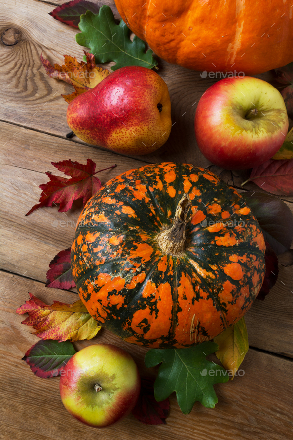 Fall decor with pumpkin, apples and red pear Stock Photo by TasiPas