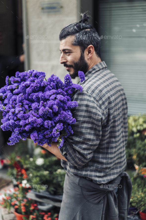 Young male florist working in flower shop Stock Photo by jpozzi | PhotoDune