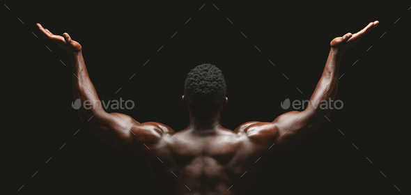 Rear view of african bodybuilder raising his palms up Stock Photo by ...