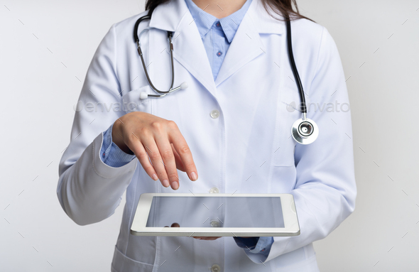 Unrecognizable Doctor Using Tablet Computer, White Background, Cropped ...
