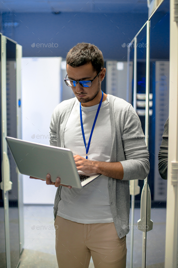 Engineer Managing Supercomputer Network Stock Photo by seventyfourimages