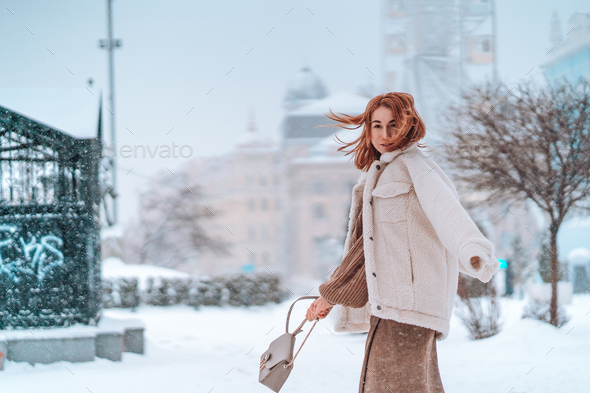 Woman outside on snowing cold winter day Stock Photo by simbiothy ...