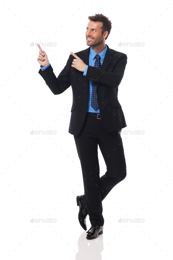 Handsome and smiling businessman pointing at copy space Stock Photo by ...