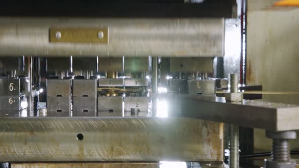 A large industrial punch press forming high precision metal parts for ...