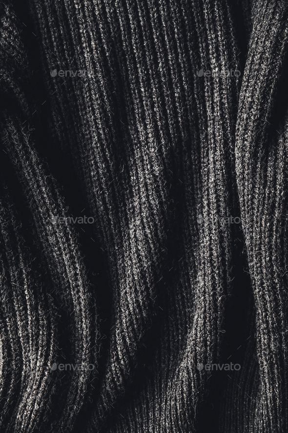 Texture of a black knitted sweater closeup. dark knitted wool material ...