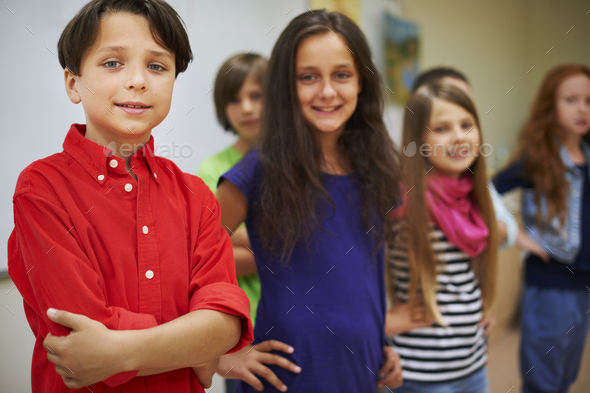 Group of pupils standing next to the whiteboard Stock Photo by gpointstudio