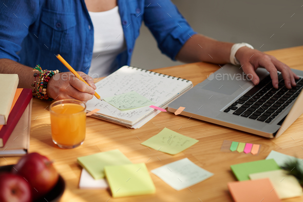 University student doing homework Stock Photo by DragonImages | PhotoDune