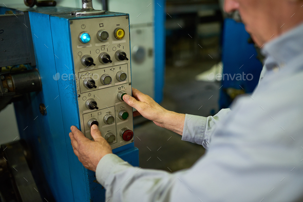 Senior Man Pressing Buttons on Control Panel Stock Photo by ...