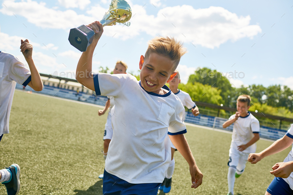 Boy Holding Trophy Cup Stock Photo by seventyfourimages | PhotoDune