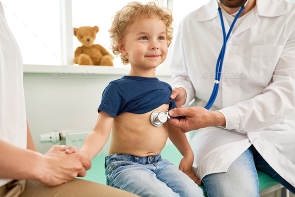 Smiling Little Boy at Medical Checkup Stock Photo by seventyfourimages