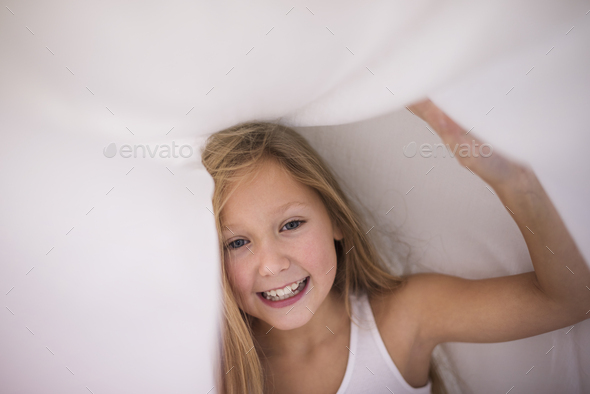 Little girl hiding under the sheet Stock Photo by gpointstudio | PhotoDune