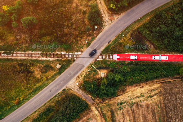 Aerial view of car and train on road junction Stock Photo by stevanovicigor