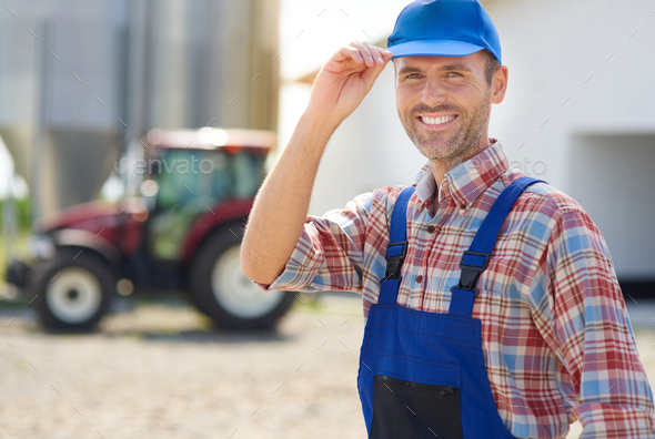Happy farmer and his big farm Stock Photo by gpointstudio | PhotoDune