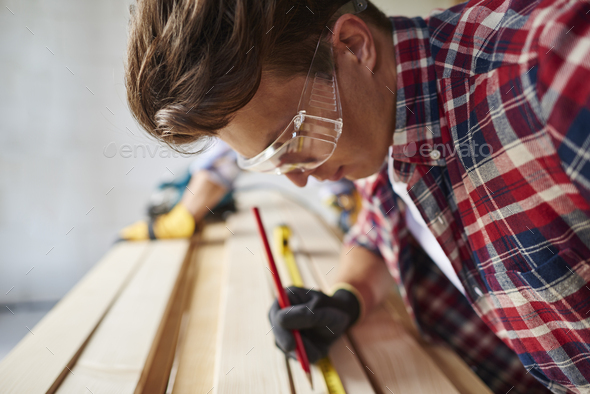 Another measurement done by building worker Stock Photo by gpointstudio