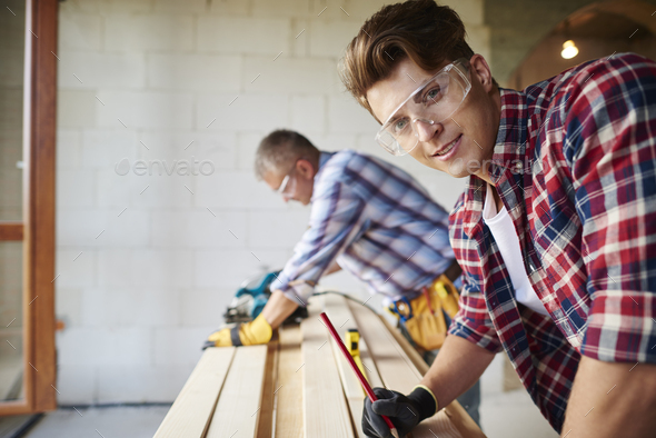 Another snapshot of hard working carpenters Stock Photo by gpointstudio