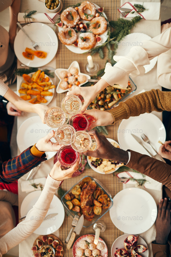 Toasting over Dinner Table Stock Photo by seventyfourimages | PhotoDune