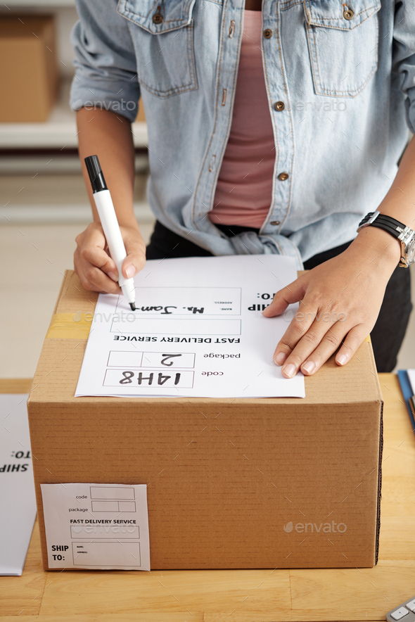 Filling address and name on package Stock Photo by DragonImages | PhotoDune