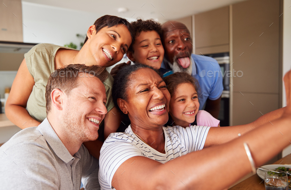 Multi-Generation Mixed Race Family Posing For Selfie As They Eat Meal ...