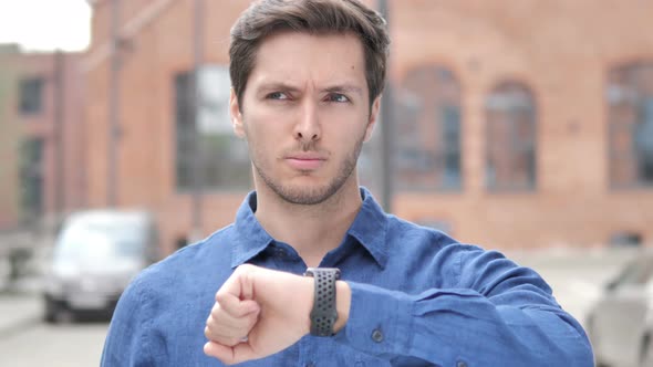 Outdoor Portrait of Waiting Young Man Watching Time on Watch, Stock Footage