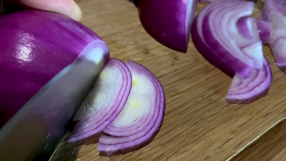 Cutting Red Onion with Kitchen Knife on Cutting Board on Chopping Board ...
