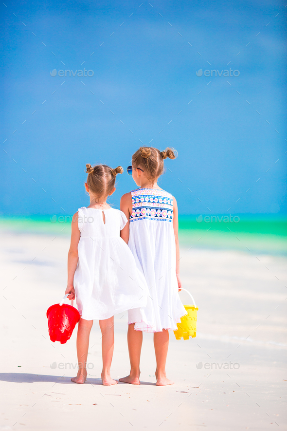 Adorable little girls during summer vacation Stock Photo by travnikovstudio