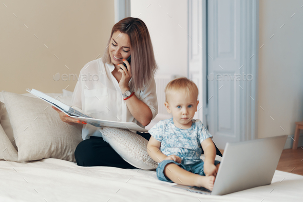 Modern woman working with child. Multi-tasking, freelance and ...