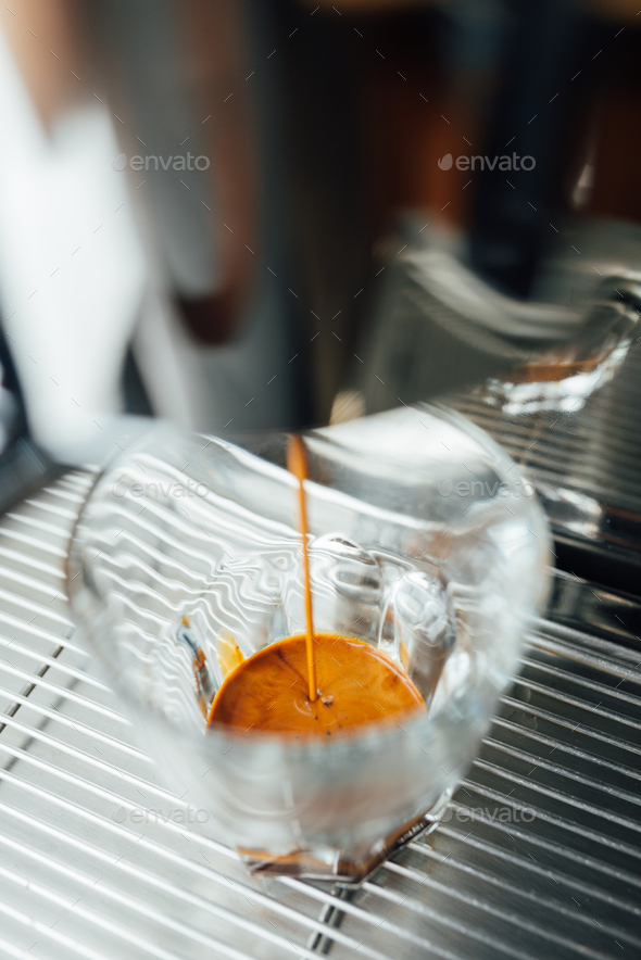 extraction of coffee from a coffee machine into glass cup Stock Photo ...