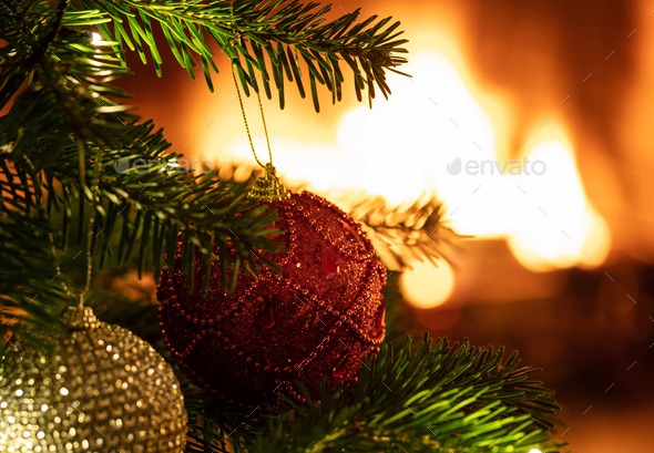 Christmas tree close up on blur fireplace background Stock Photo by rawf8