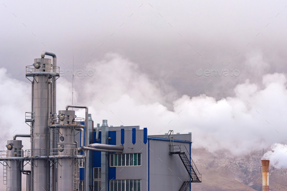 Air pollution by factory smoke. Grey factory against cloudy sky Stock ...