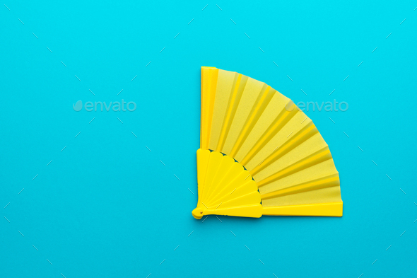 Minimalist Photo Of Yellow Hand Fan On Turquoise Blue Background With ...