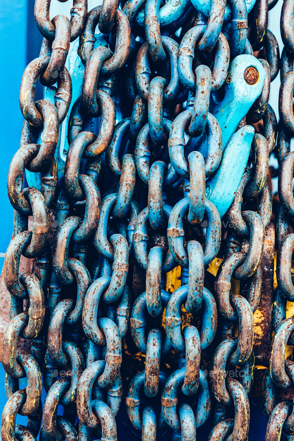 Heavy iron chain in a factory, workshop. Industry Stock Photo by photocreo