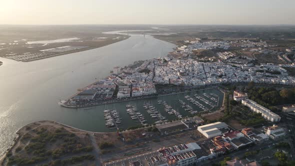 Aerial forward view of coastal town of Ayamonte with its marina ...
