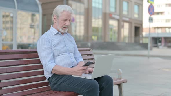 Old Man Using Smartphone and Laptop While Sitting Outdoor on Bench ...